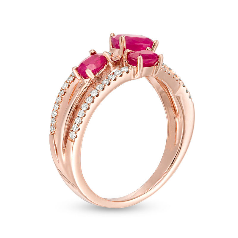 Oval Ruby and 1/5 CT. T.W. Diamond Three Stone Orbit Ring in 10K Rose ...